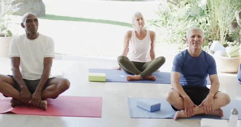 Happy diverse seniors sitting on mats at... | Stock Video | Pond5