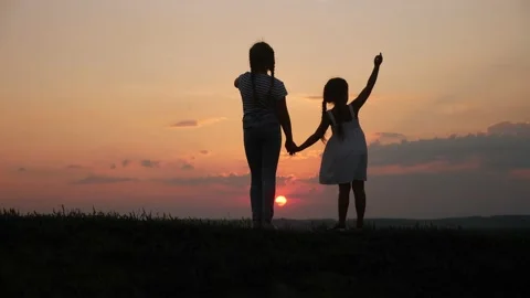 happy family two sisters walks at sunset... | Stock Video | Pond5