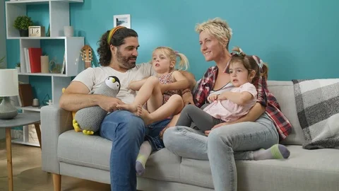 Happy family watch funny cartoons sit on... | Stock Video | Pond5