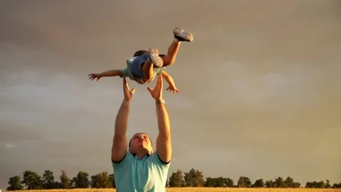 Happy father is throwing his son in the ... | Stock Video | Pond5