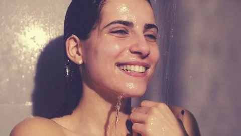 Happy female model under the shower maki... | Stock Video | Pond5
