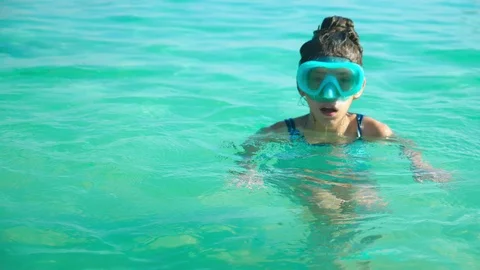 happy girl in a swimming mask emerges fr... | Stock Video | Pond5
