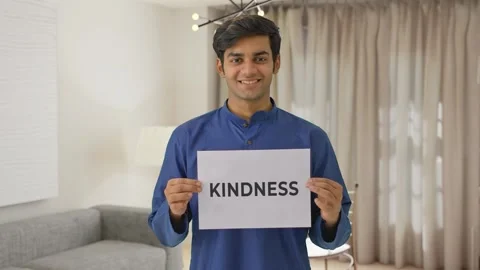Happy Indian boy holding KINDNESS banner | Stock Video | Pond5