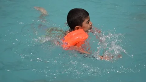 Happy Indian boy swimming in a pool, Kid... | Stock Video | Pond5