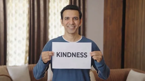 Happy Indian man holding KINDNESS banner | Stock Video | Pond5