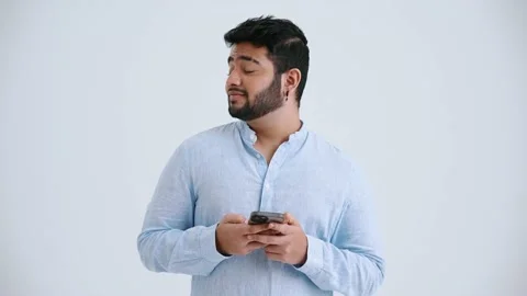 Happy Indian man with piercing typing on... | Stock Video | Pond5