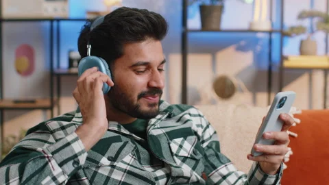 Happy indian man in wireless headphones ... | Stock Video | Pond5
