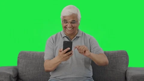 Happy Indian old man scrolling through p... | Stock Video | Pond5