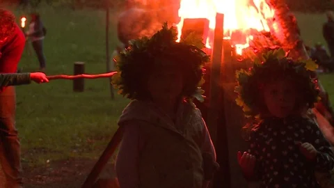 Happy kids near big fire bonfire in mids... | Stock Video | Pond5