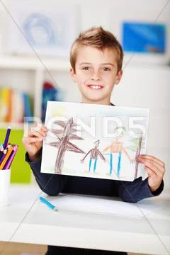 Happy little boy displaying drawing at table Stock Photo #26254670