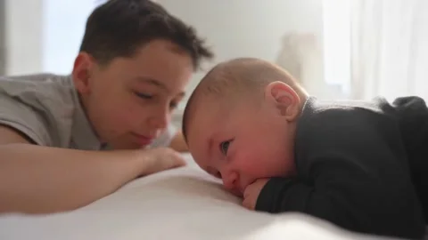 Happy little brother with newborn baby l... | Stock Video | Pond5