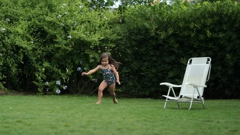Happy little girl child running in slow-... | Stock Video | Pond5