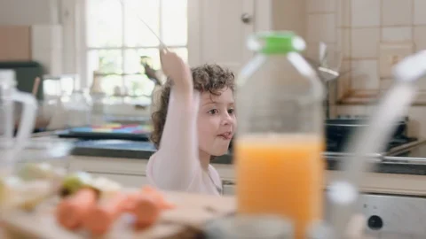 happy little girl dancing in kitchen hav... | Stock Video | Pond5
