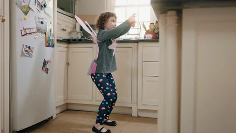 happy little girl dancing in kitchen wea... | Stock Video | Pond5