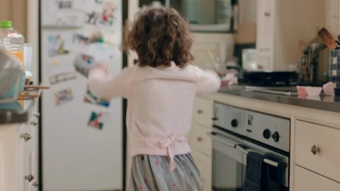 happy little girl dancing in kitchen hav... | Stock Video | Pond5