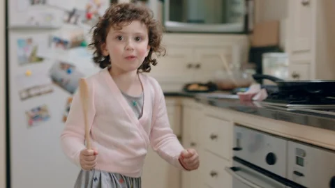 happy little girl dancing in kitchen hav... | Stock Video | Pond5