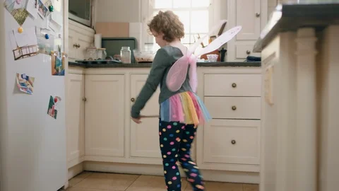 happy little girl dancing in kitchen wea... | Stock Video | Pond5