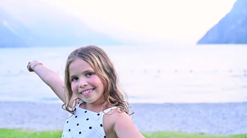 Happy little girl exudes emotions of joy... | Stock Video | Pond5