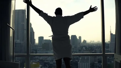 Happy man in bathrobe jumping and raisin... | Stock Video | Pond5