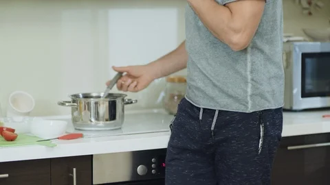 Happy man cooking healthy dinner at luxu... | Stock Video | Pond5