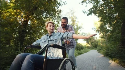 Happy man rolls emotional disabled woman... | Stock Video | Pond5