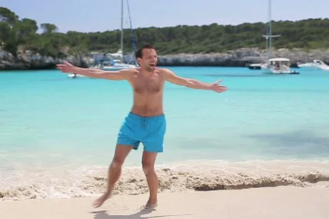 Happy man running and turning around at ... | Stock Video | Pond5