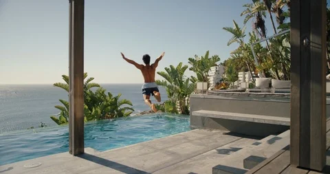 happy man running jumping in swimming po... | Stock Video | Pond5