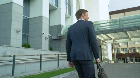 Happy man walking to office building, be... | Stock Video | Pond5
