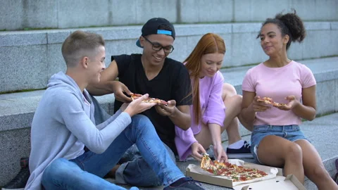 Happy multiethnic teen friends eating pi... | Stock Video | Pond5
