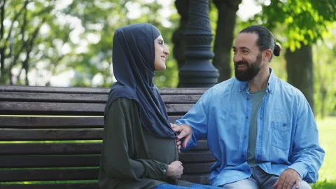 Happy Muslim couple talking on bench in ... | Stock Video | Pond5