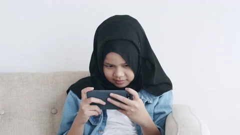 Happy Muslim girl playing a game online ... | Stock Video | Pond5