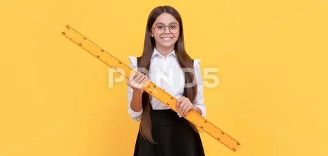 Happy nerd kid in school uniform and glasses hold mathematics ruler for ...