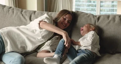 Happy playful mom tickling excited screa... | Stock Video | Pond5