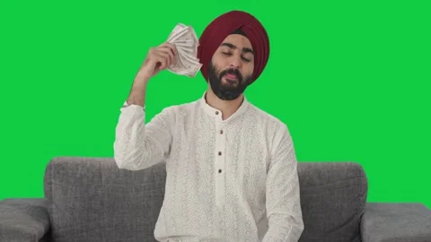 Happy Sikh Indian man using money as fan... | Stock Video | Pond5