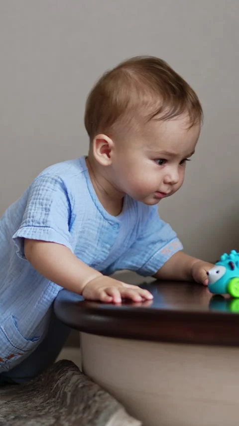 Happy smiley baby boy standing on his kn... | Stock Video | Pond5