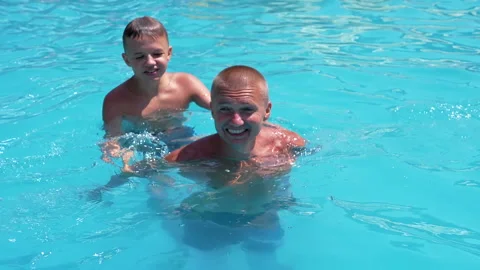 Happy Smiling Father with Son Swim in Op... | Stock Video | Pond5