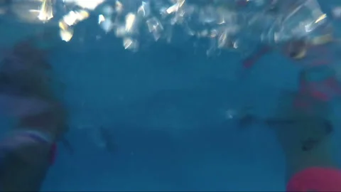 Happy smiling girls dive in swimming poo... | Stock Video | Pond5