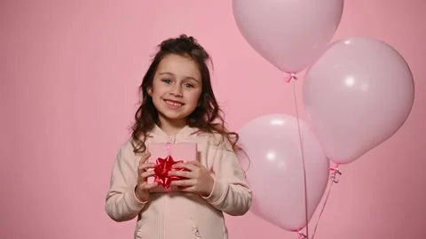 Happy smiling little girl cutely posing ... | Stock Video | Pond5