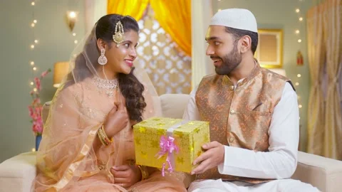 Happy smiling muslim husband giving gift... | Stock Video | Pond5