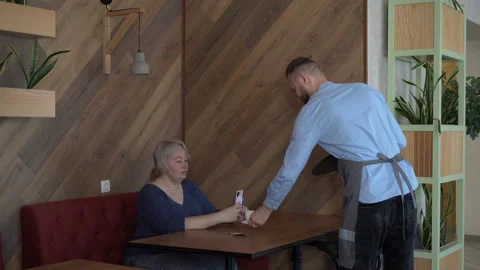 Happy waiter enjoys a big tip while work... | Stock Video | Pond5