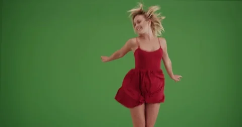 Happy woman dancing in a red dress on gr... | Stock Video | Pond5