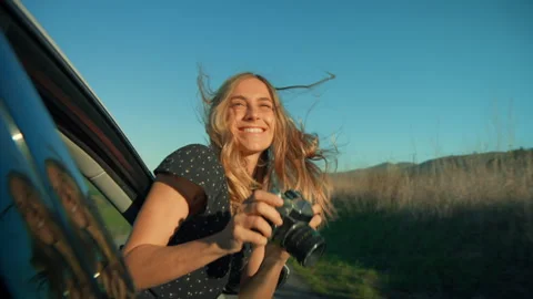 Happy woman hang out of car window with ... | Stock Video | Pond5