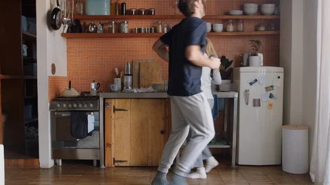 happy young couple dancing in kitchen en... | Stock Video | Pond5