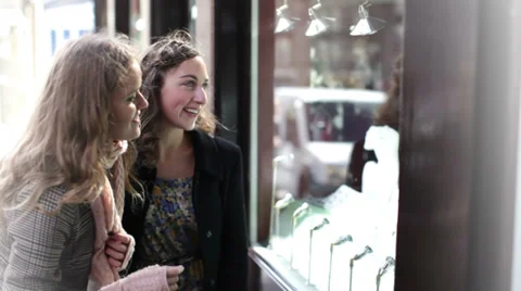 Happy young female friends window shoppi... | Stock Video | Pond5