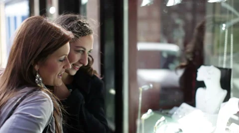 Happy young female friends window shoppi... | Stock Video | Pond5