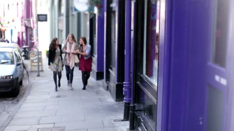 Happy young female friends window shoppi... | Stock Video | Pond5