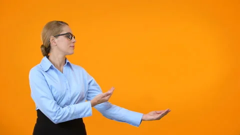 Happy young female pointing hands on bri... | Stock Video | Pond5