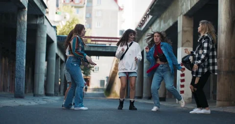 Happy young girls running on street sing... | Stock Video | Pond5