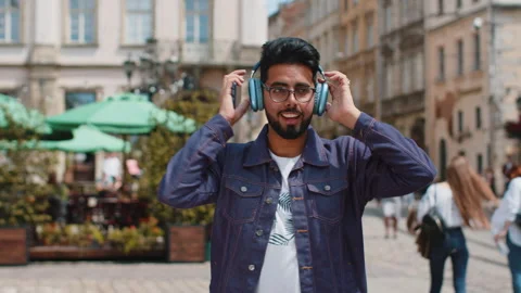 Happy young indian man in wireless headp... | Stock Video | Pond5