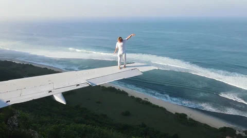 Happy young man dancing on the wing of a... | Stock Video | Pond5